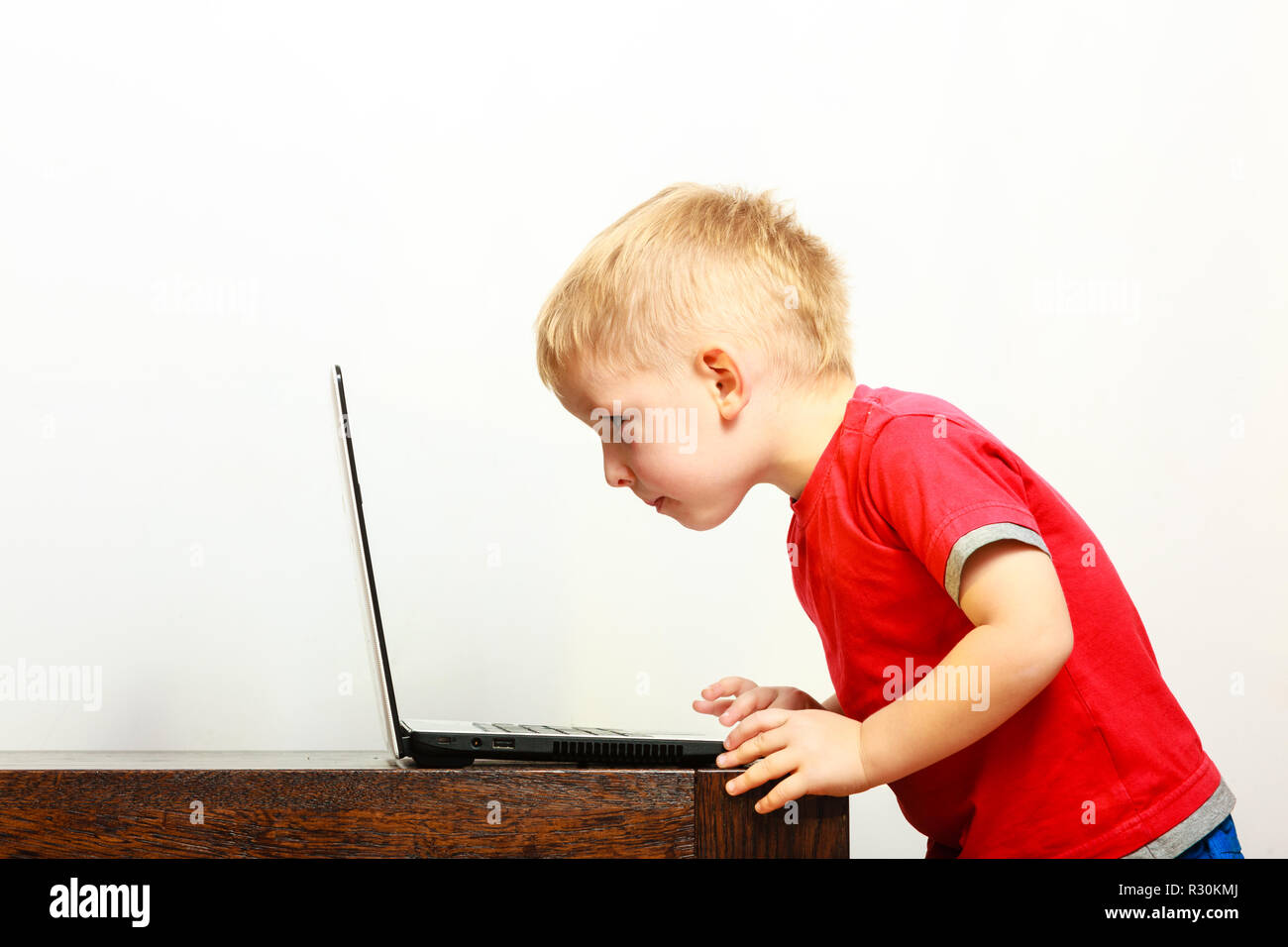 Children, technology and home concept - little boy kid child using ...