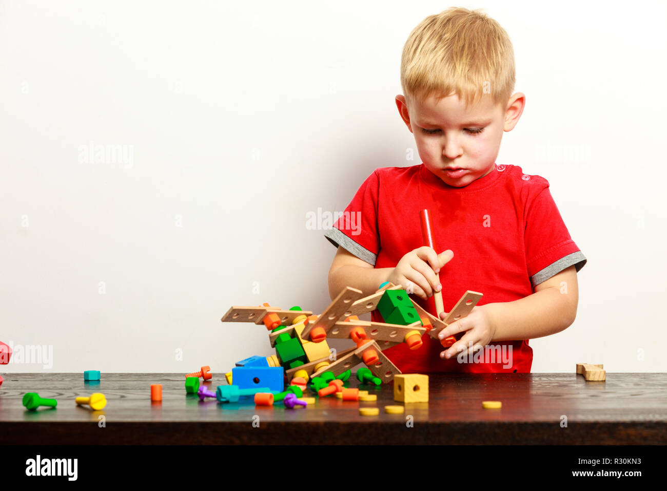 Little blond boy child kid preschooler playing with colorful building ...