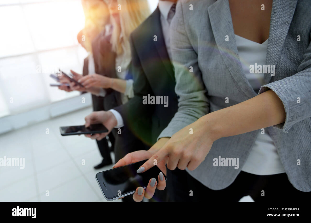 closeup.a group of employees with smartphones Stock Photo - Alamy