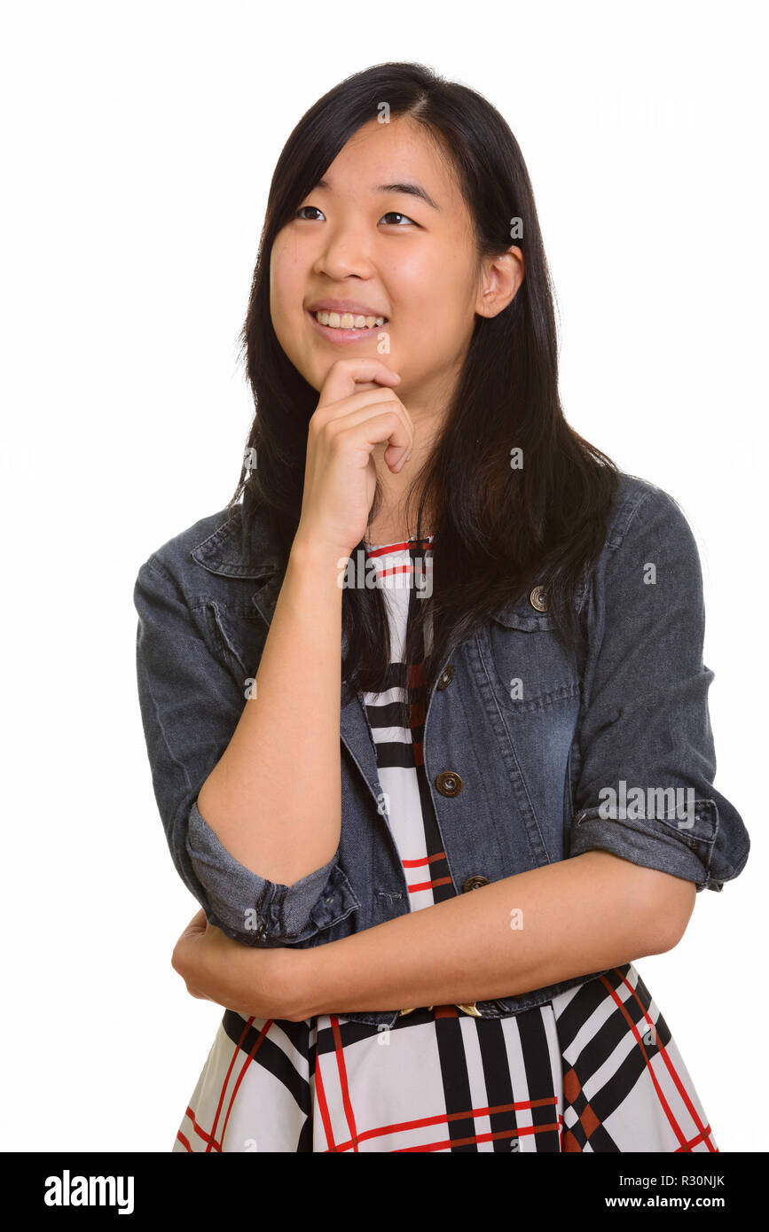Young happy Asian woman thinking and looking up Stock Photo - Alamy