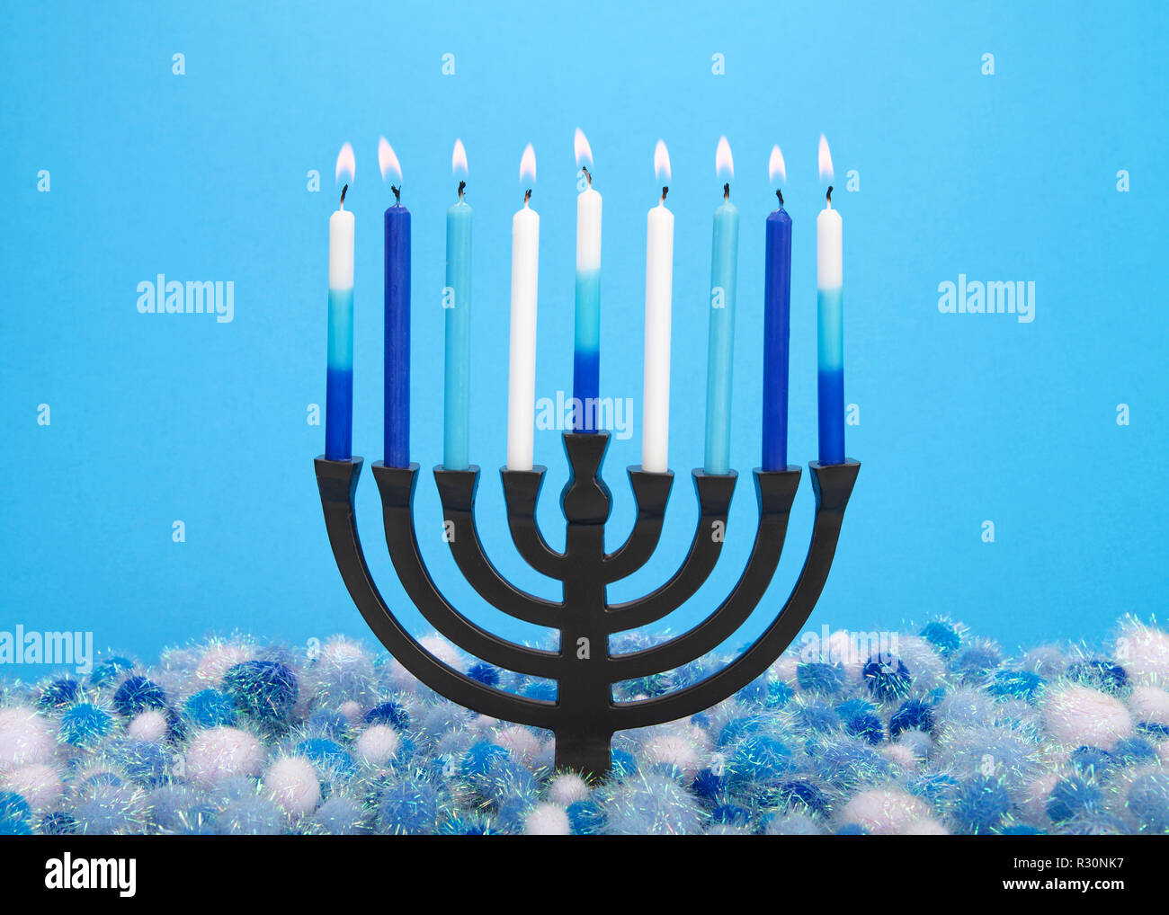a nine-branched menorah (also called a Chanukiah or Hanukiah) burning ...
