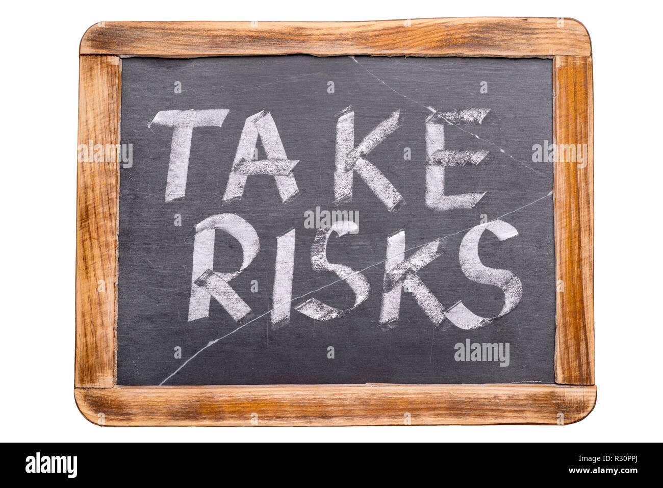 take risks phrase handwritten on vintage school slate board isolated on ...