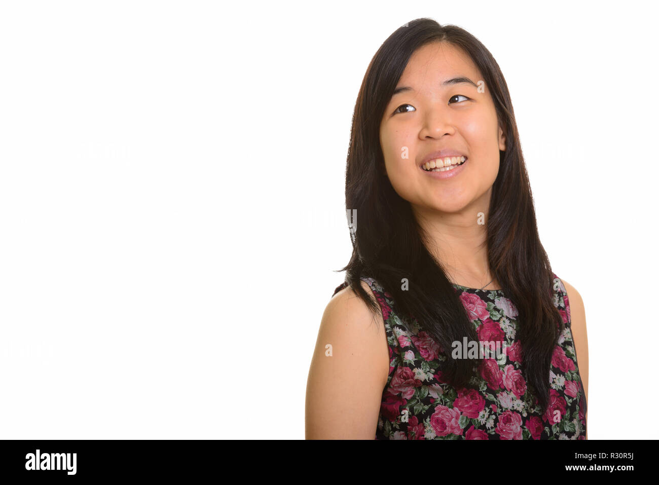 Portrait of young happy Asian woman thinking and smiling Stock Photo ...