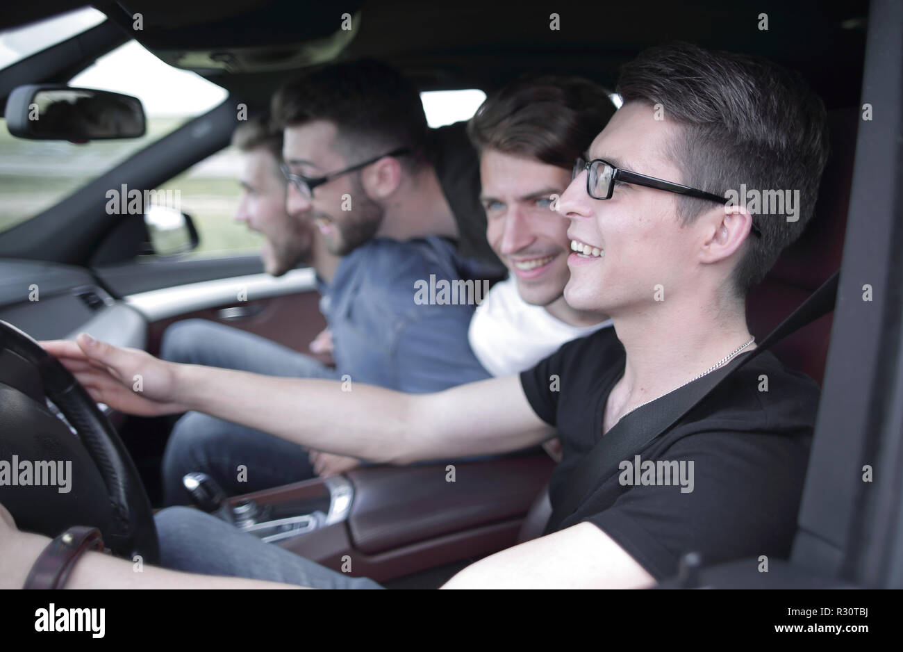 A young man rides in a car at high speed Stock Photo - Alamy