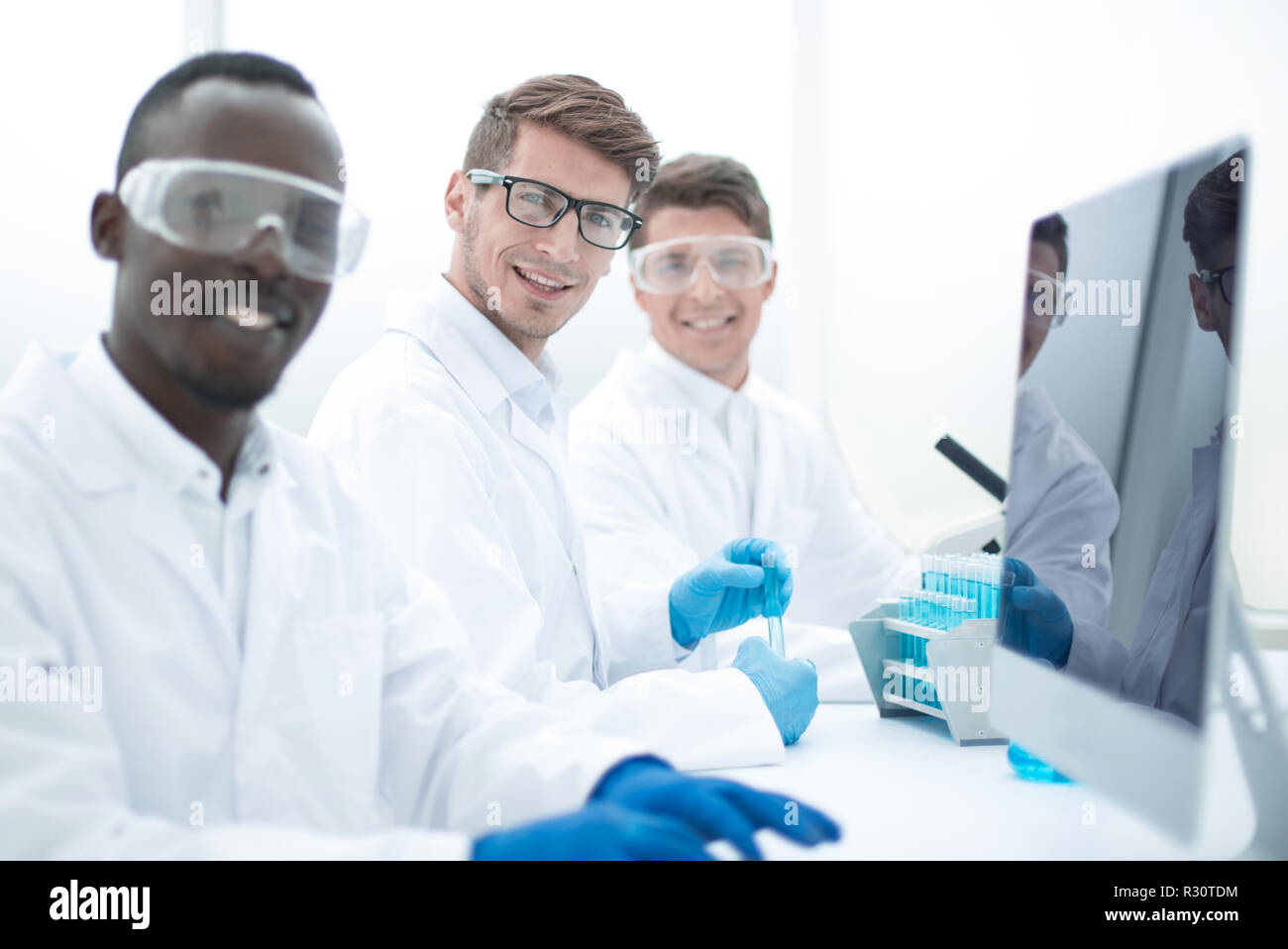 successful group of scientists sitting at their Desk Stock Photo - Alamy
