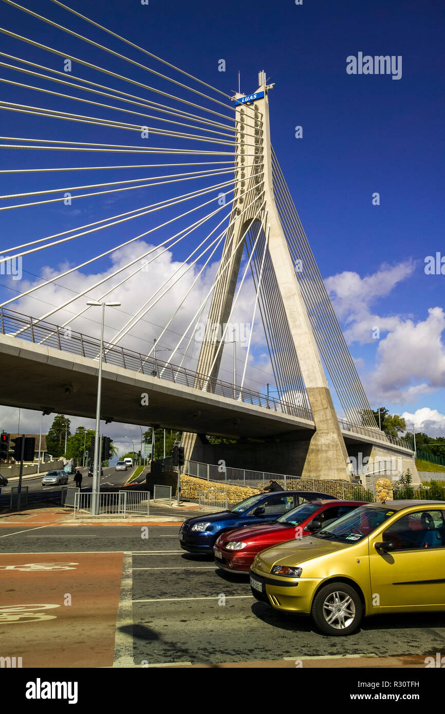 Cars waiting at traffic signal under the LUAS rail bridge at Dundrum ...