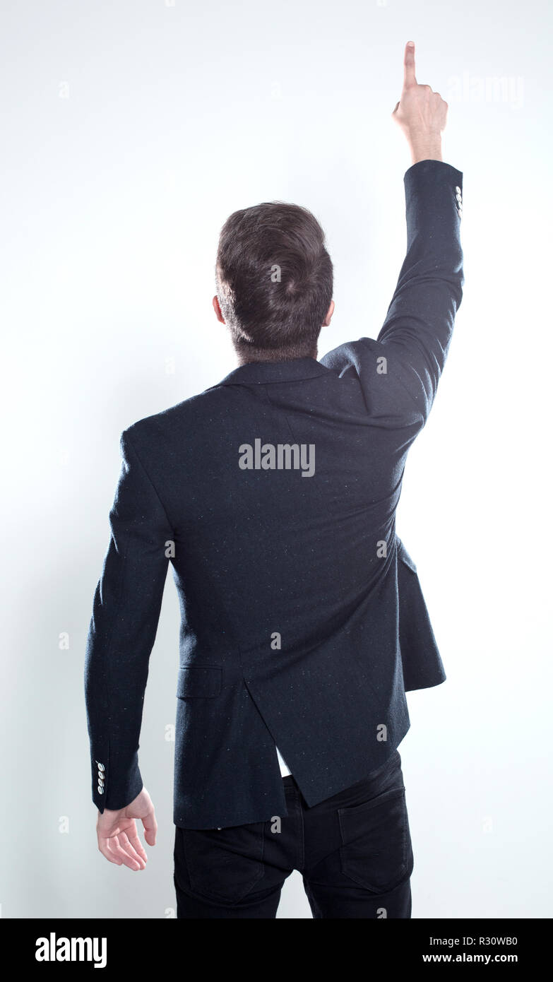 Attractive young man in suit pointing up with his finger isolate Stock ...