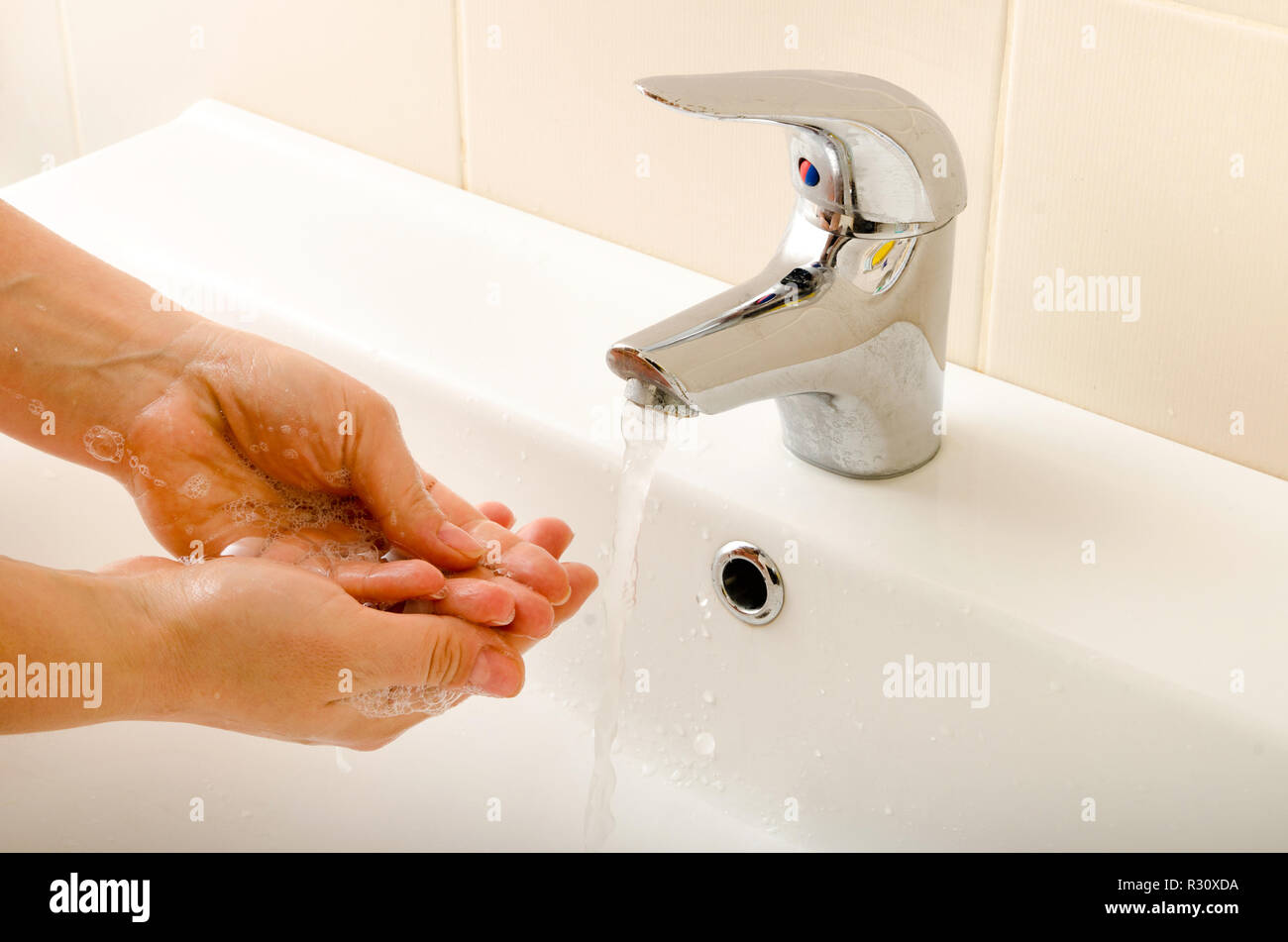 hand washing under the tap closeup Stock Photo - Alamy