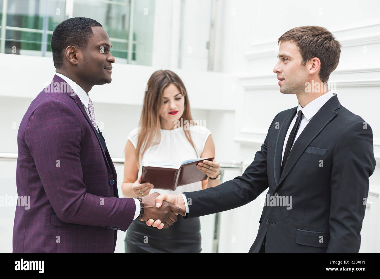 Successful smiling businessmen shake hi-res stock photography and ...