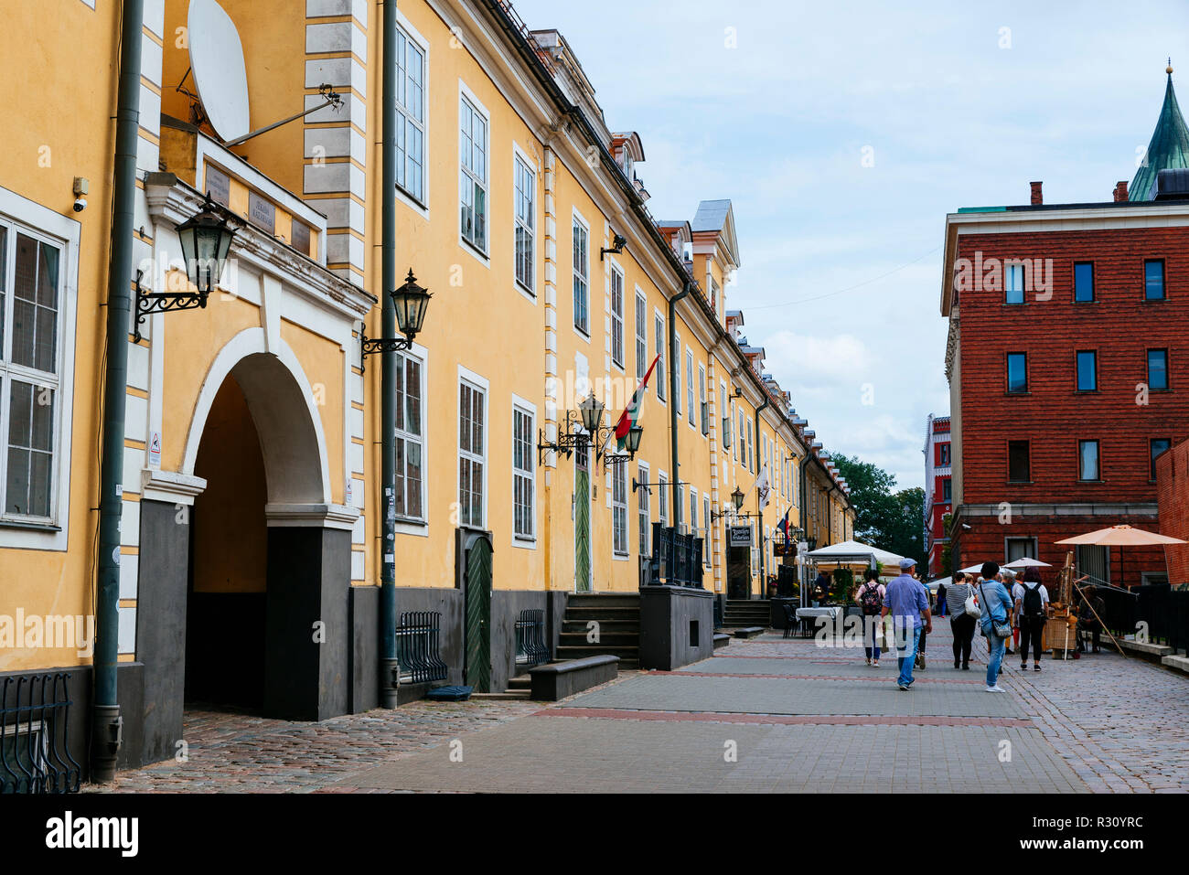 The collection of red-roofed buildings along Torņa Street on one side ...