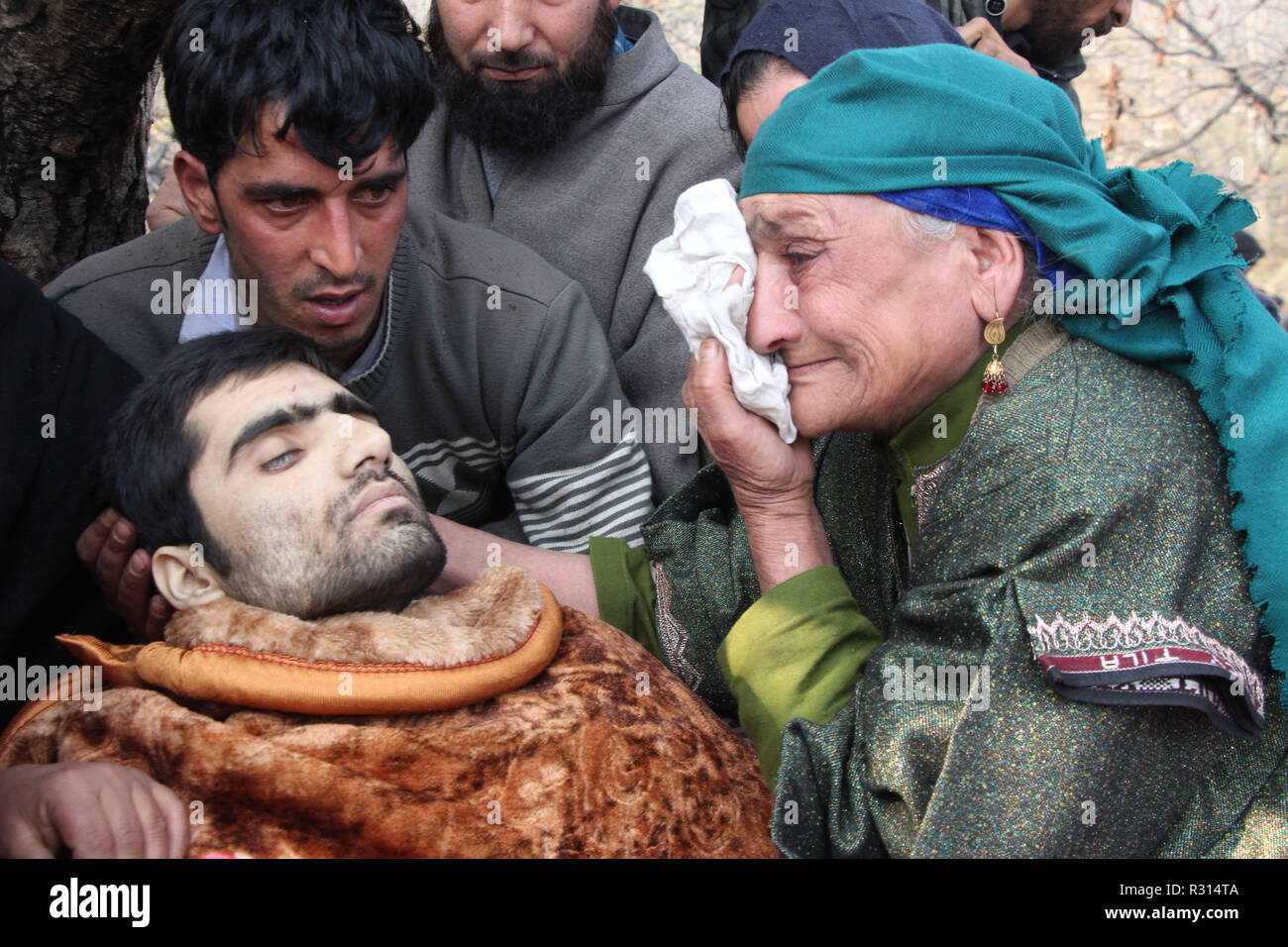 Shopian, Jammu and Kashmir, India. 20th Nov, 2018. A relative weeps as ...