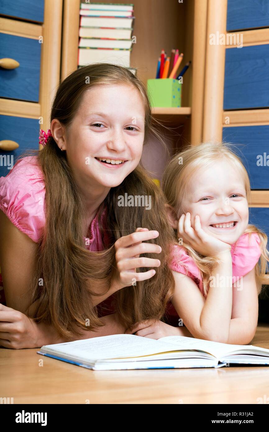 two girls reads book in your room Stock Photo - Alamy