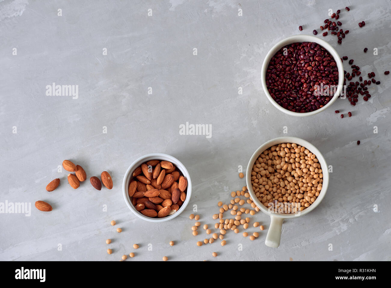 various dried beans with kitchen utensils on gray table, top view Stock ...