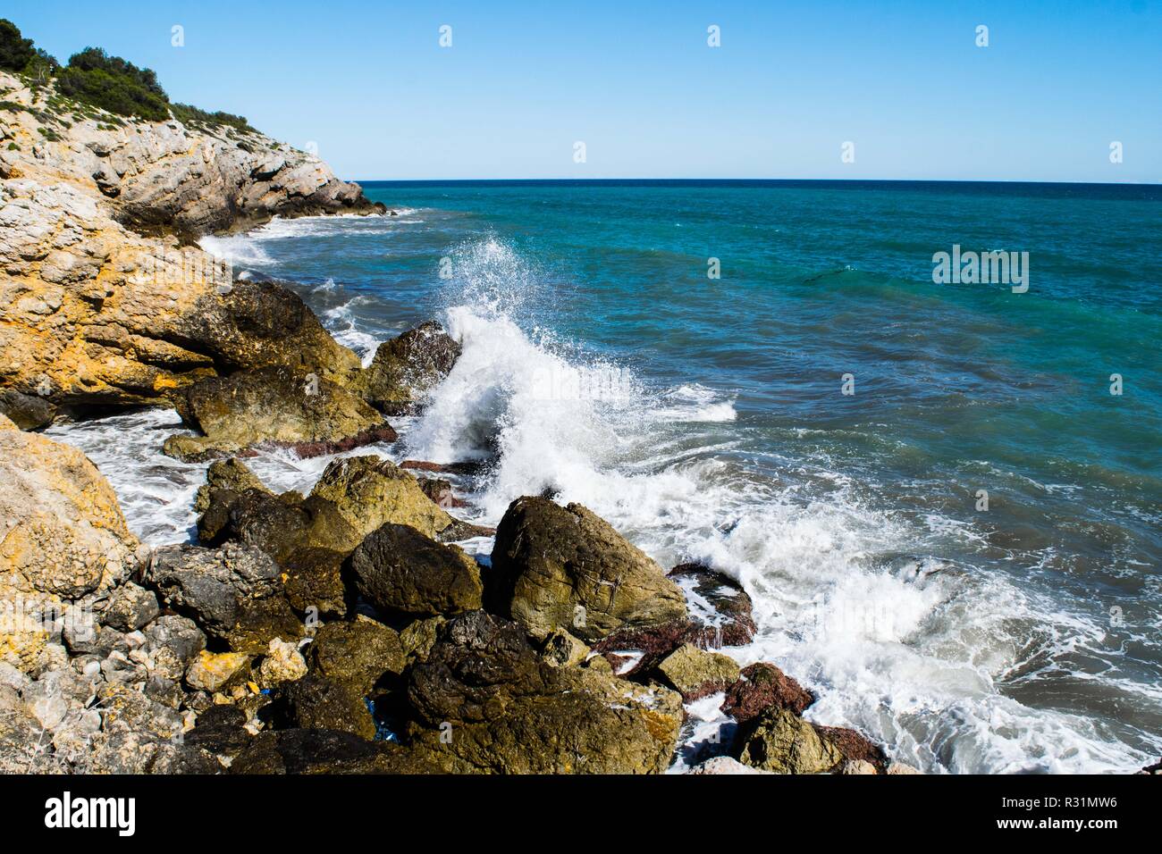 Water splash on rocky coastline, Spain Stock Photo - Alamy