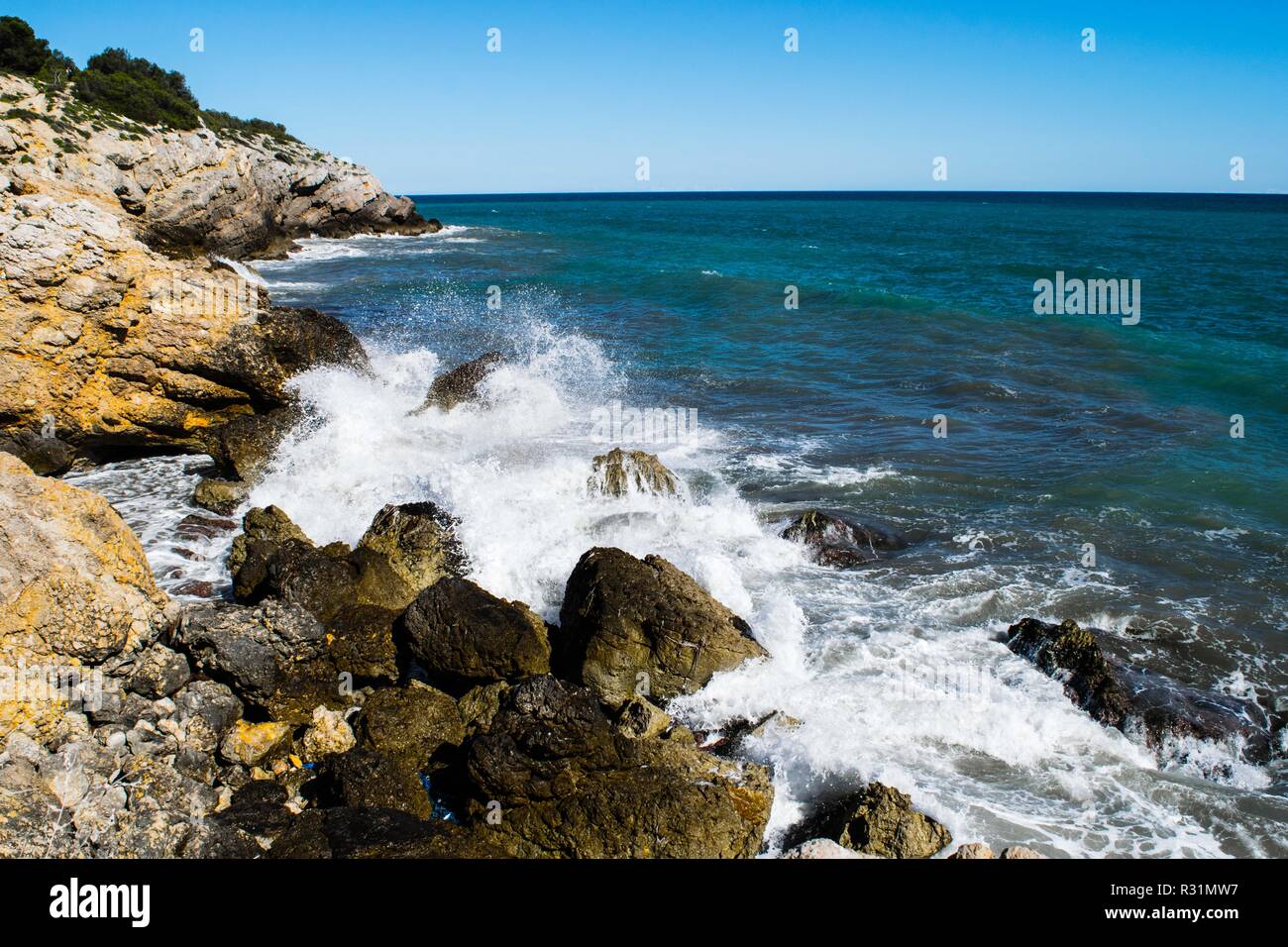 Water splash on rocky coastline, Spain Stock Photo - Alamy