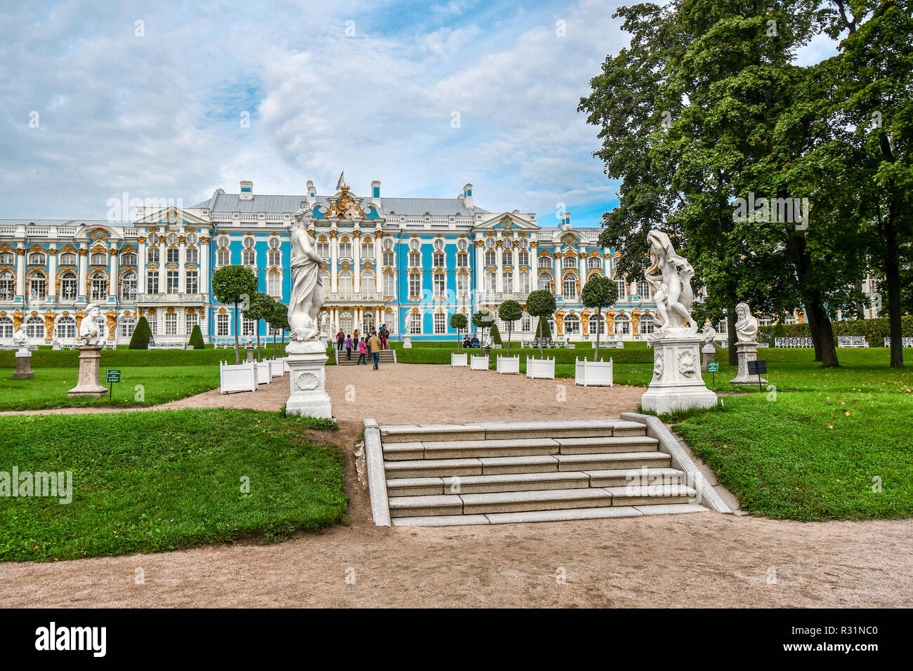 Travelers enjoy the gardens and the ornate facade of the Rococo ...