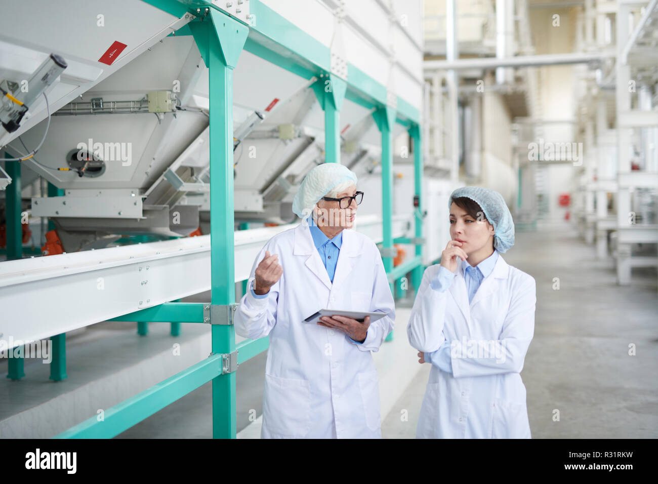 Senior Worker Instructing Trainee Stock Photo - Alamy