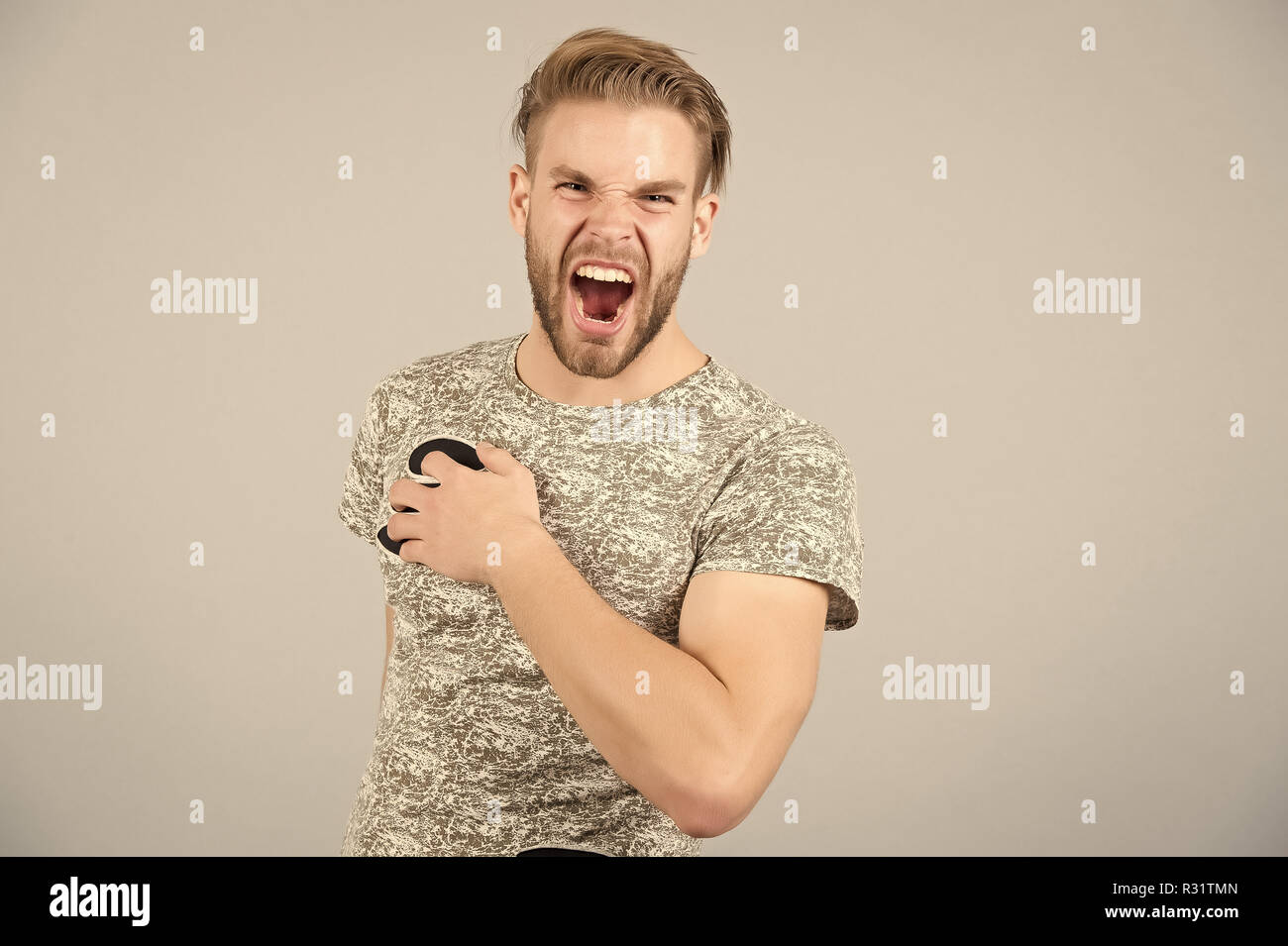 Macho with beard on angry face and stylish hair, haircut. Man in tshirt ...