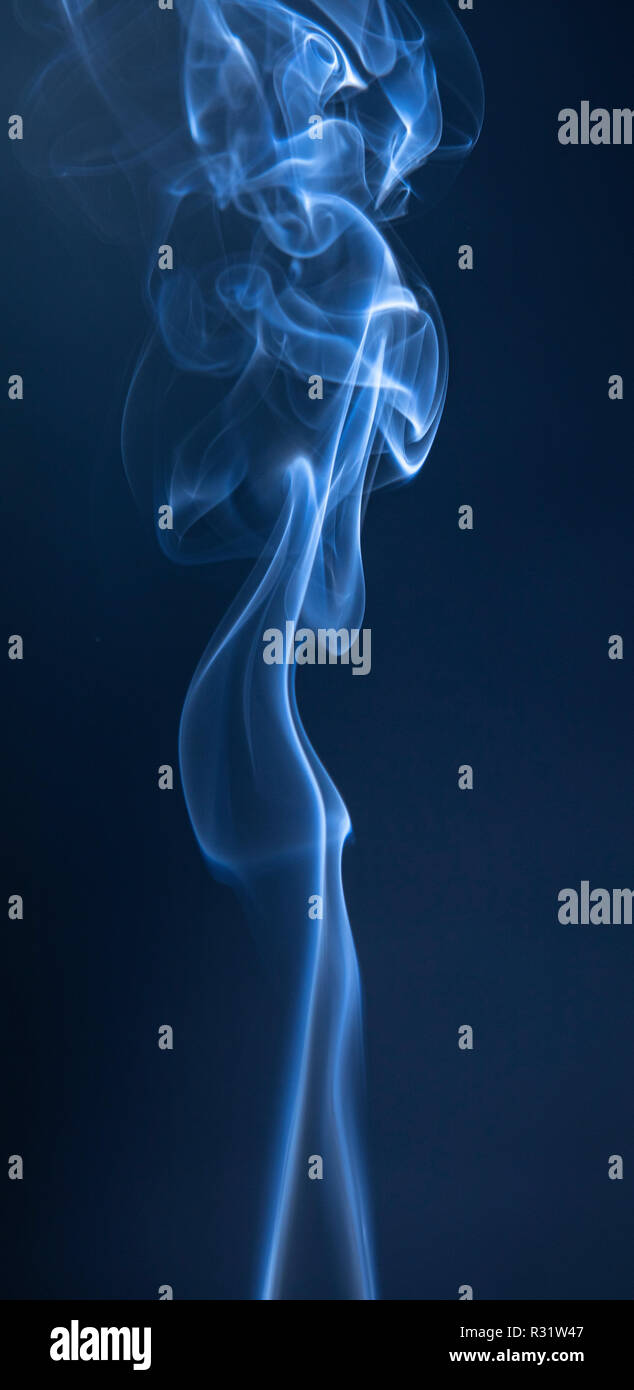 Abstract blue smoke swirls on dark background Stock Photo - Alamy