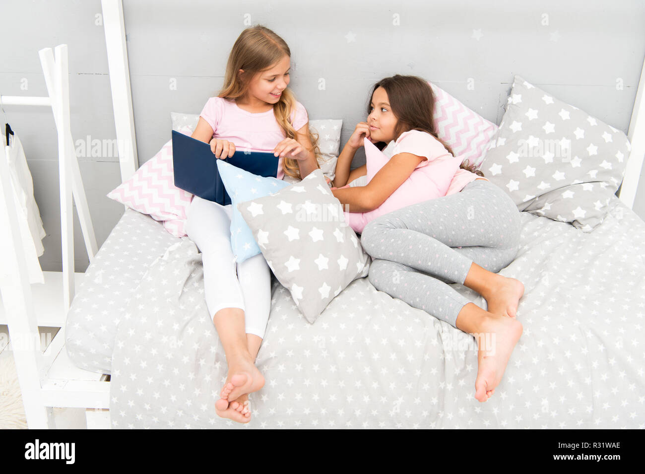 Kids prepare go to bed. Pleasant time cozy bedroom. Girls long hair ...