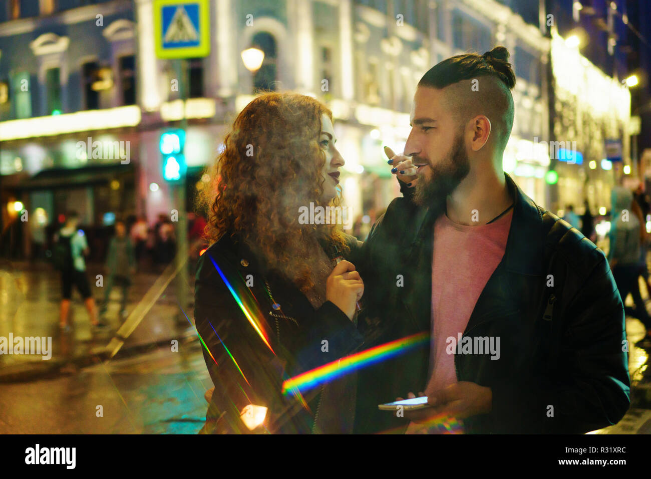 Couple in love on date. Boyfriend looks at girlfriend. She strokes it ...