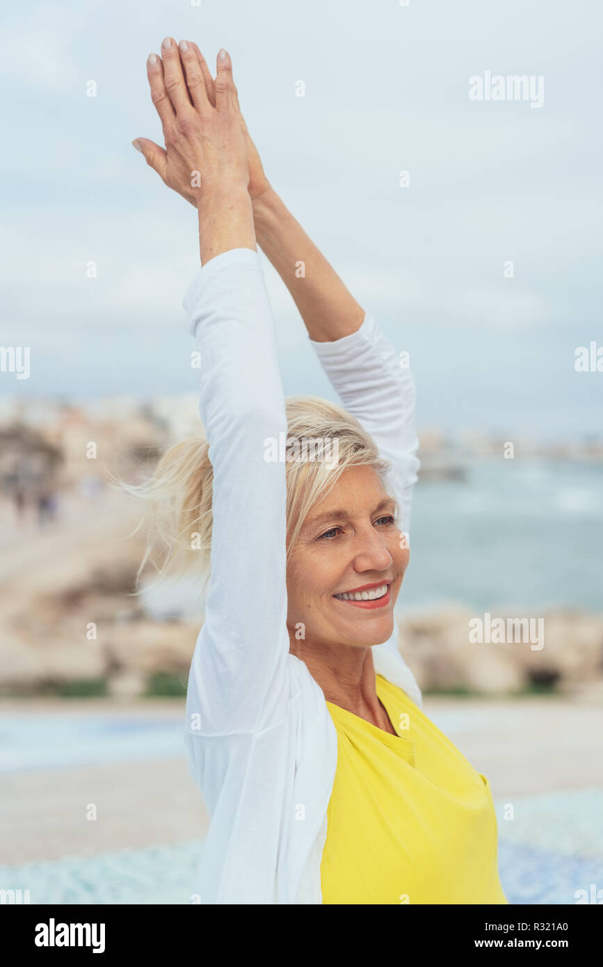 Mature woman arms raised happy hi-res stock photography and images - Alamy
