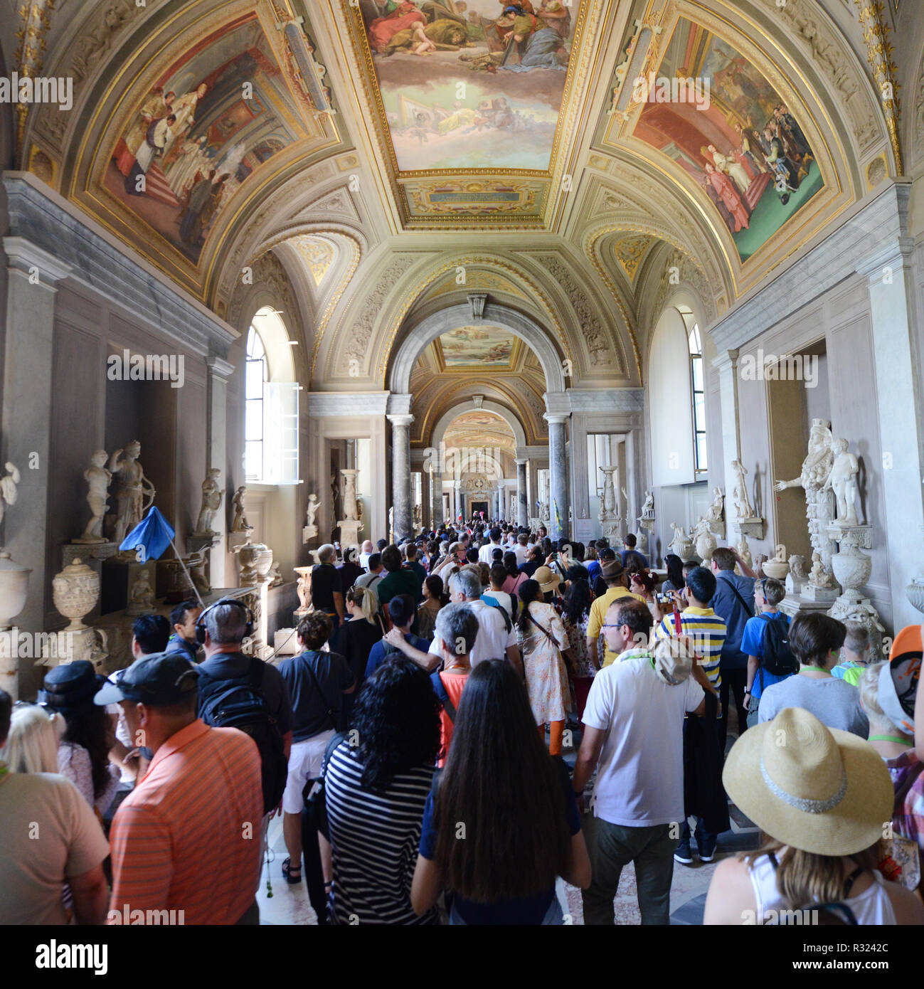Tourist rushing through t he beautiful corridors of the Vatican museum ...