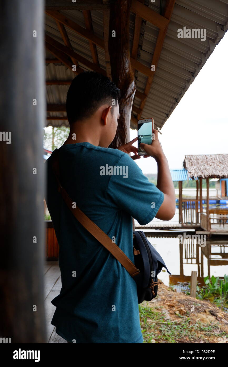 man taking photo on his mobile phone camera Stock Photo - Alamy