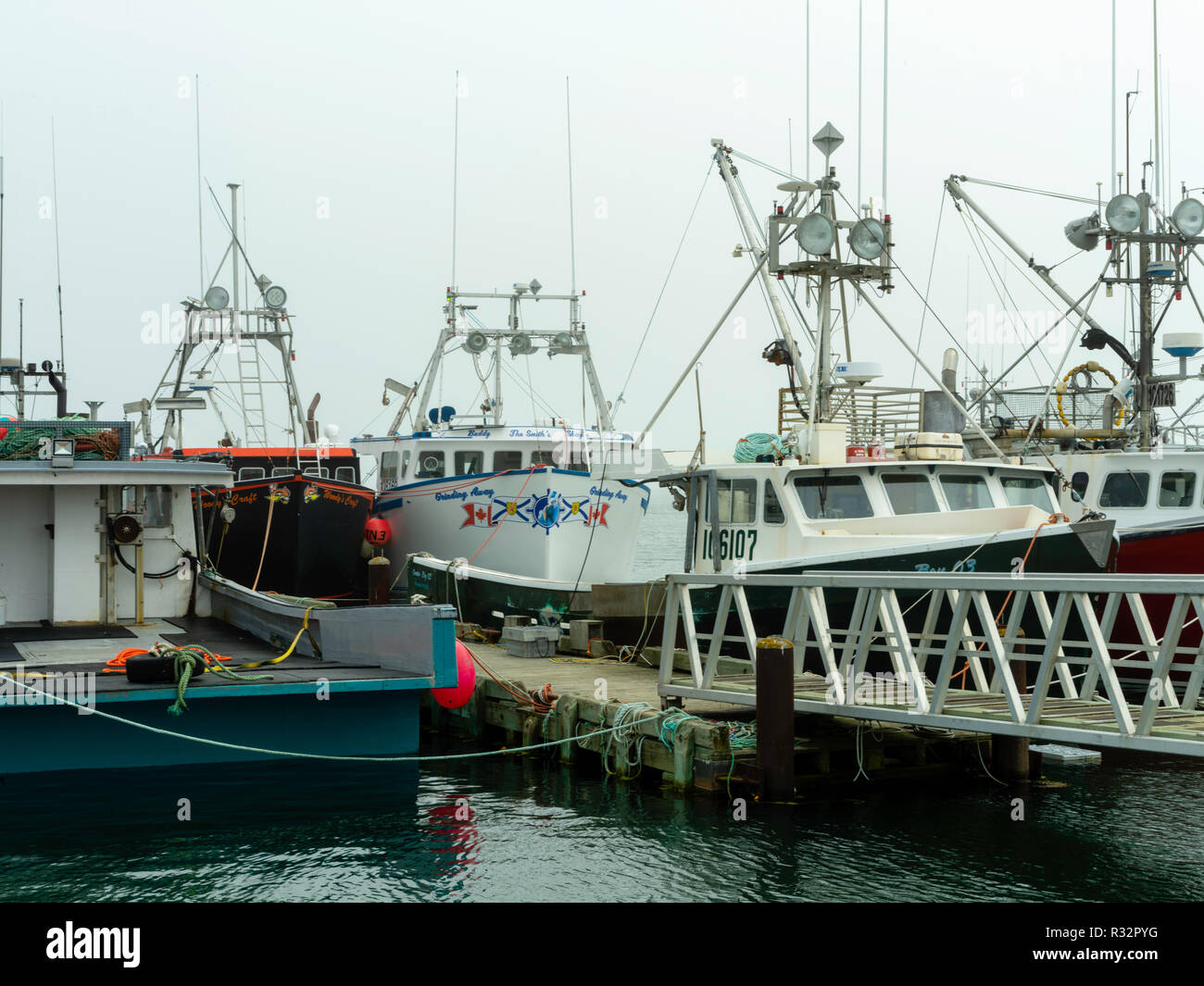 Lobster boats sit in a protected cove at Cape Forchu, Nova Scotia ...