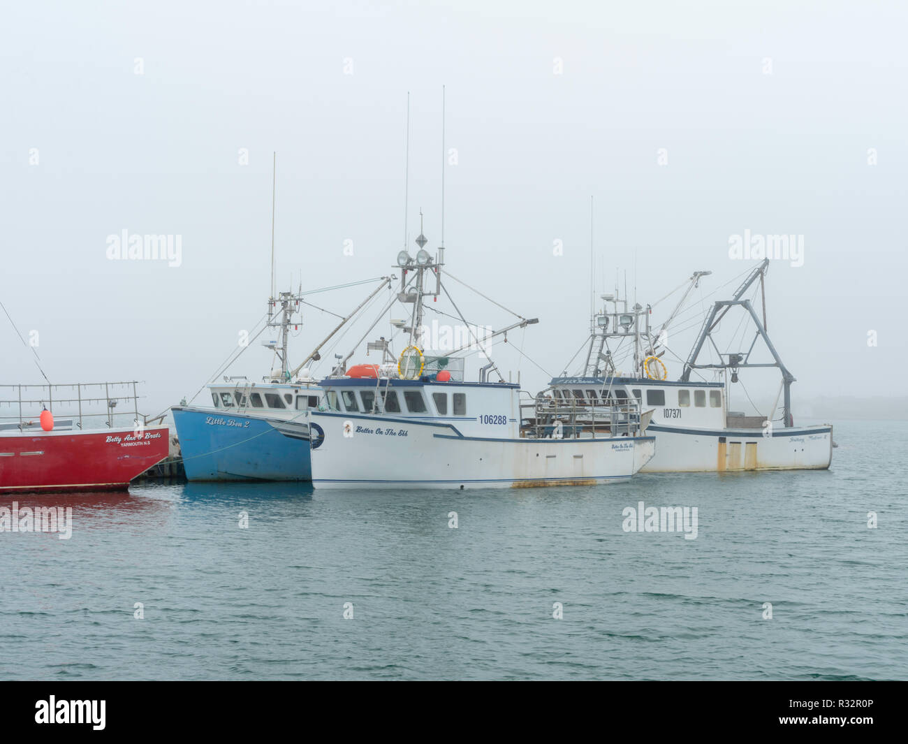 Lobster boats sit in a protected cove at Cape Forchu, Nova Scotia ...
