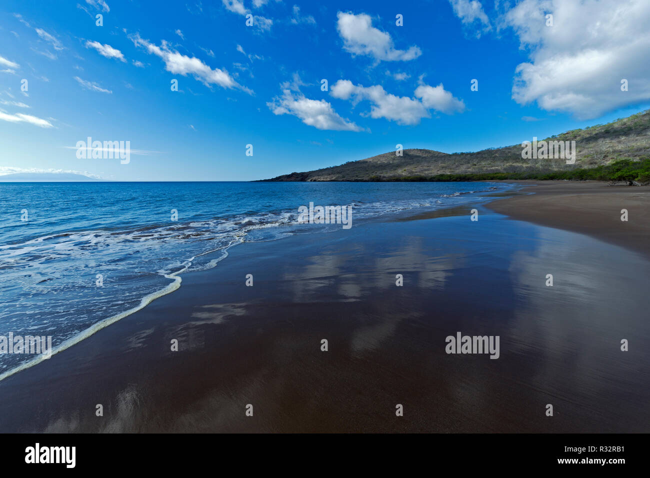 coastline and beach with clouds reflected in wet sand santiago island ...
