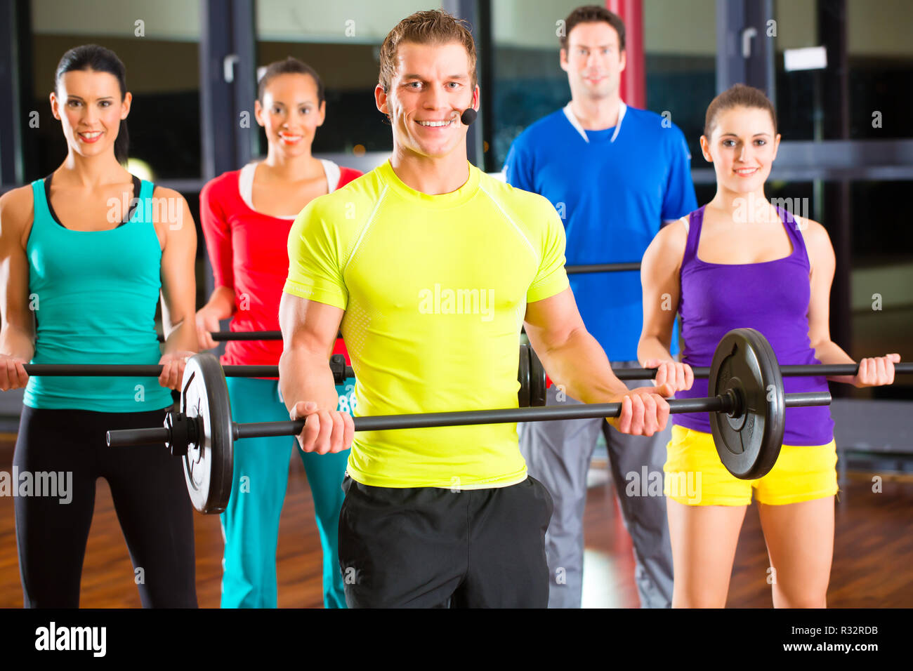group with dumbbell workout in gym Stock Photo - Alamy