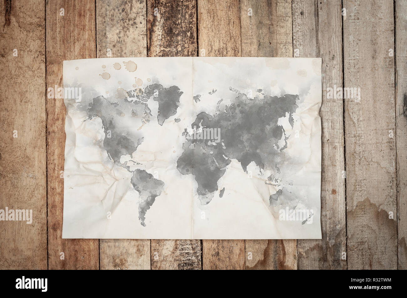World map on Vintage Crumpled paper texture on wooden table Stock Photo ...