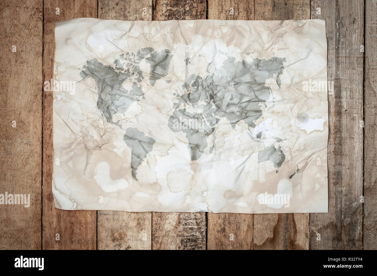 World map on Vintage Crumpled paper texture on wooden table Stock Photo ...