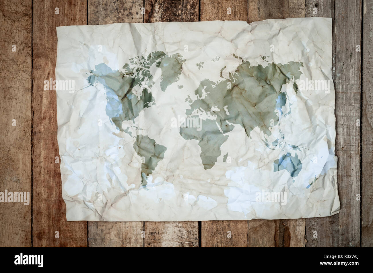 World map on Vintage Crumpled paper texture on wooden table Stock Photo ...