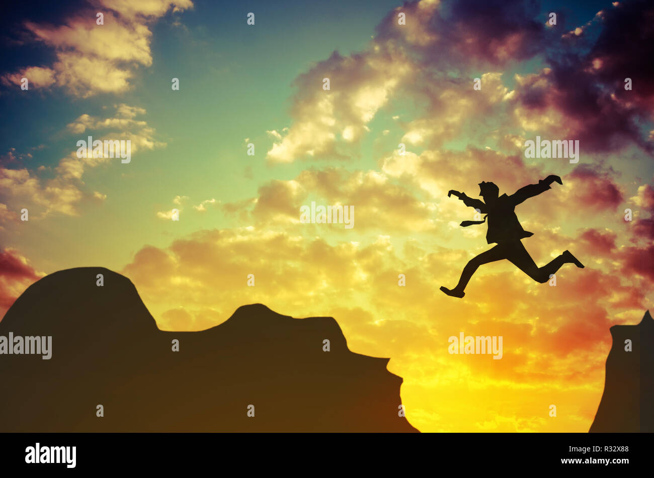 Silhouette man jumping over cliff hi-res stock photography and images ...