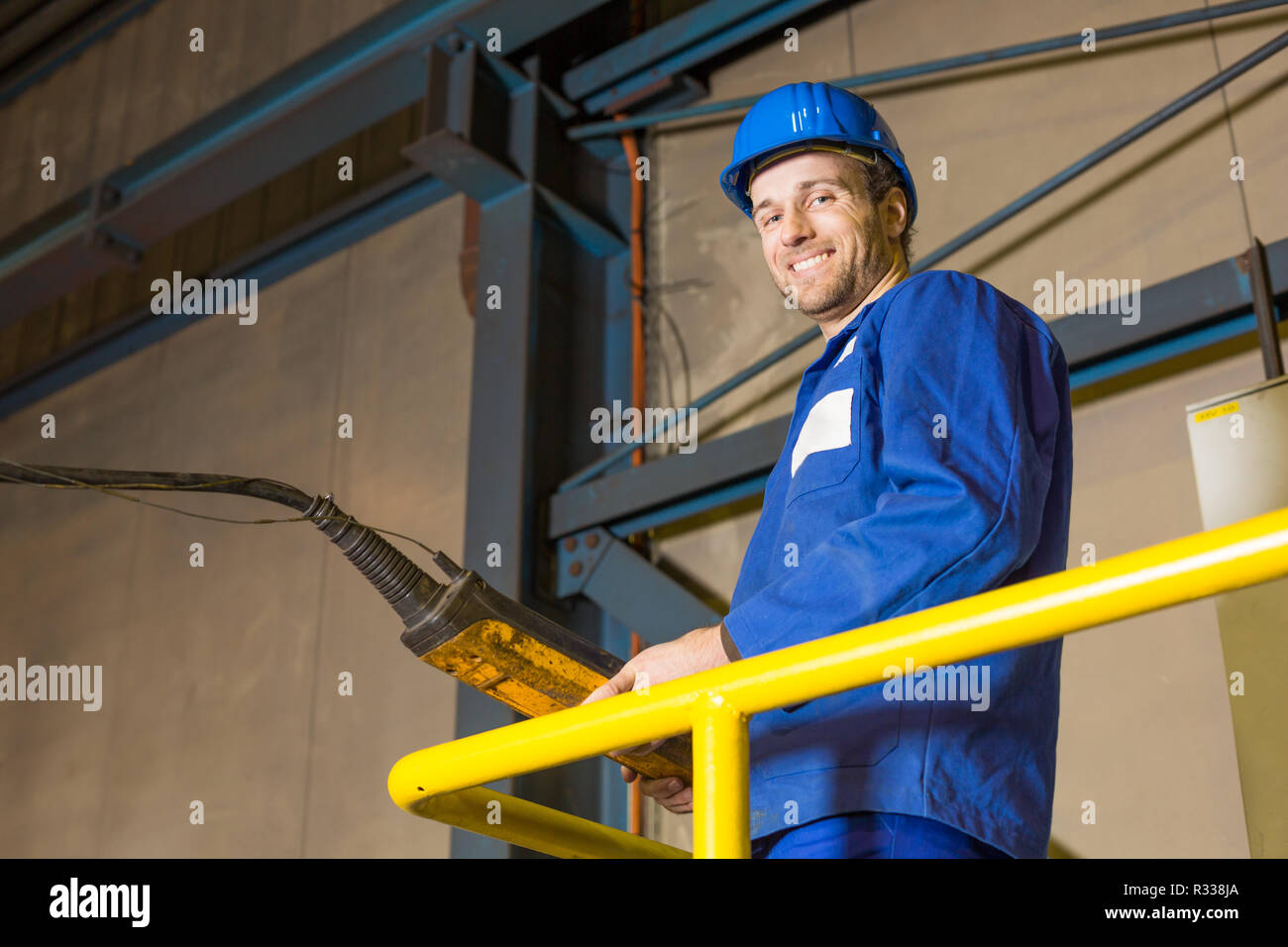 construction worker operates a machine Stock Photo - Alamy