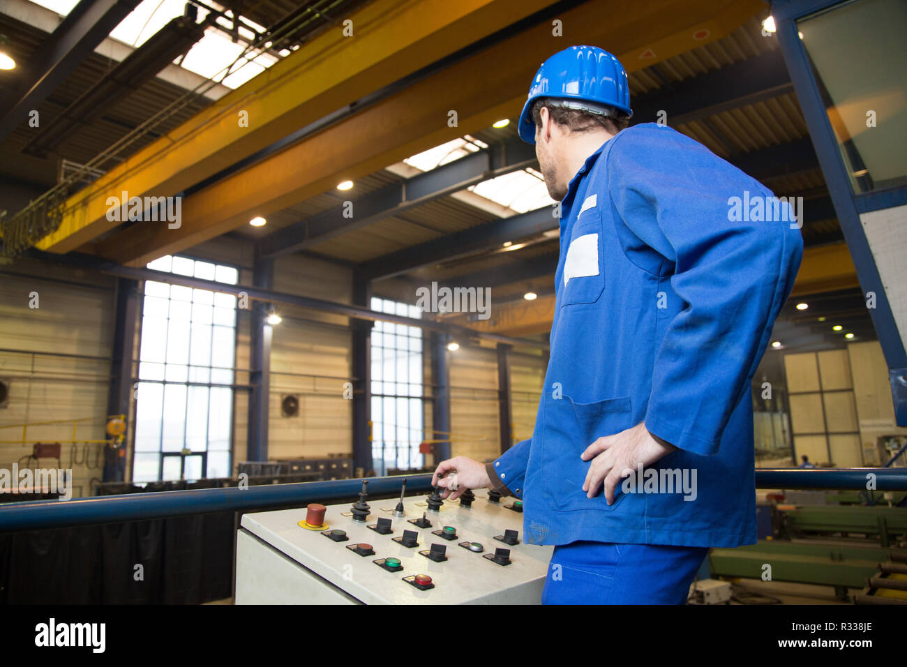 construction worker operates a machine Stock Photo - Alamy
