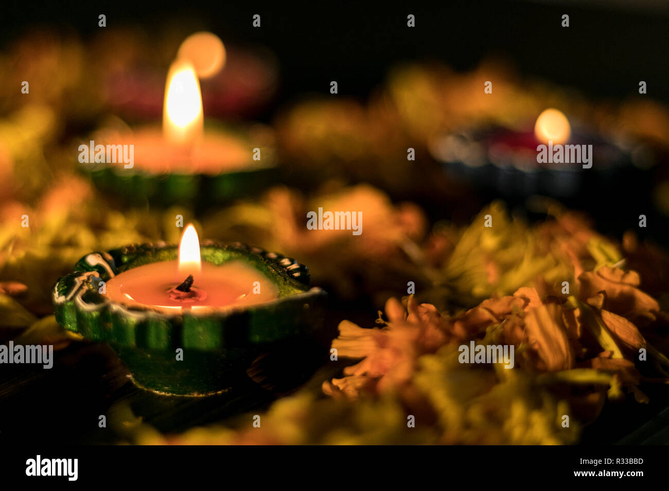 Lit diya placed on flower hi-res stock photography and images - Alamy
