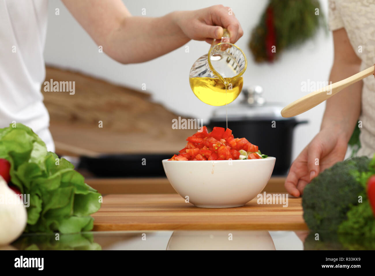 Closeup of human hands cooking in kitchen. Mother and daughter or two ...