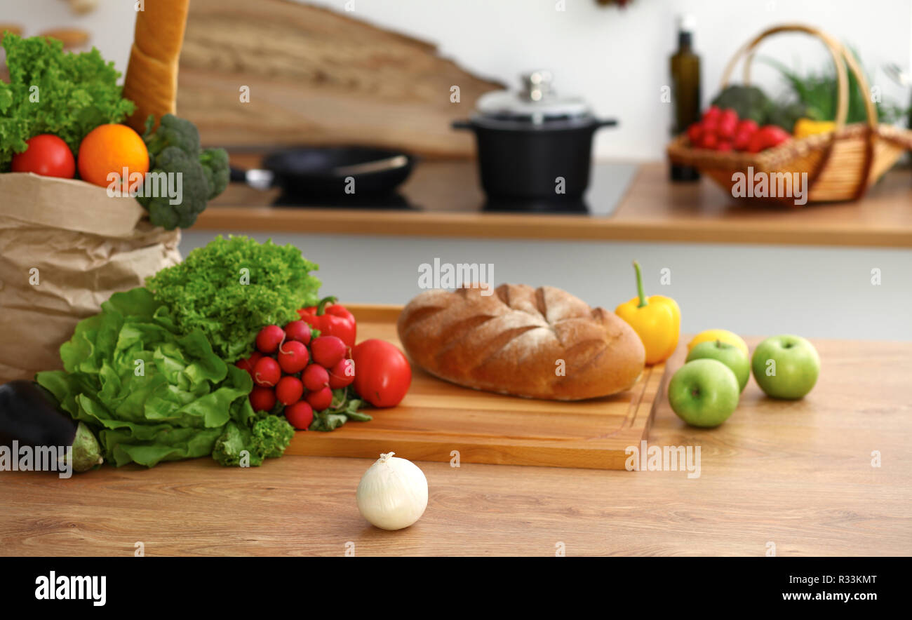 Desk with many fresh vegetables and fruits in the kitchen. Cooking ...