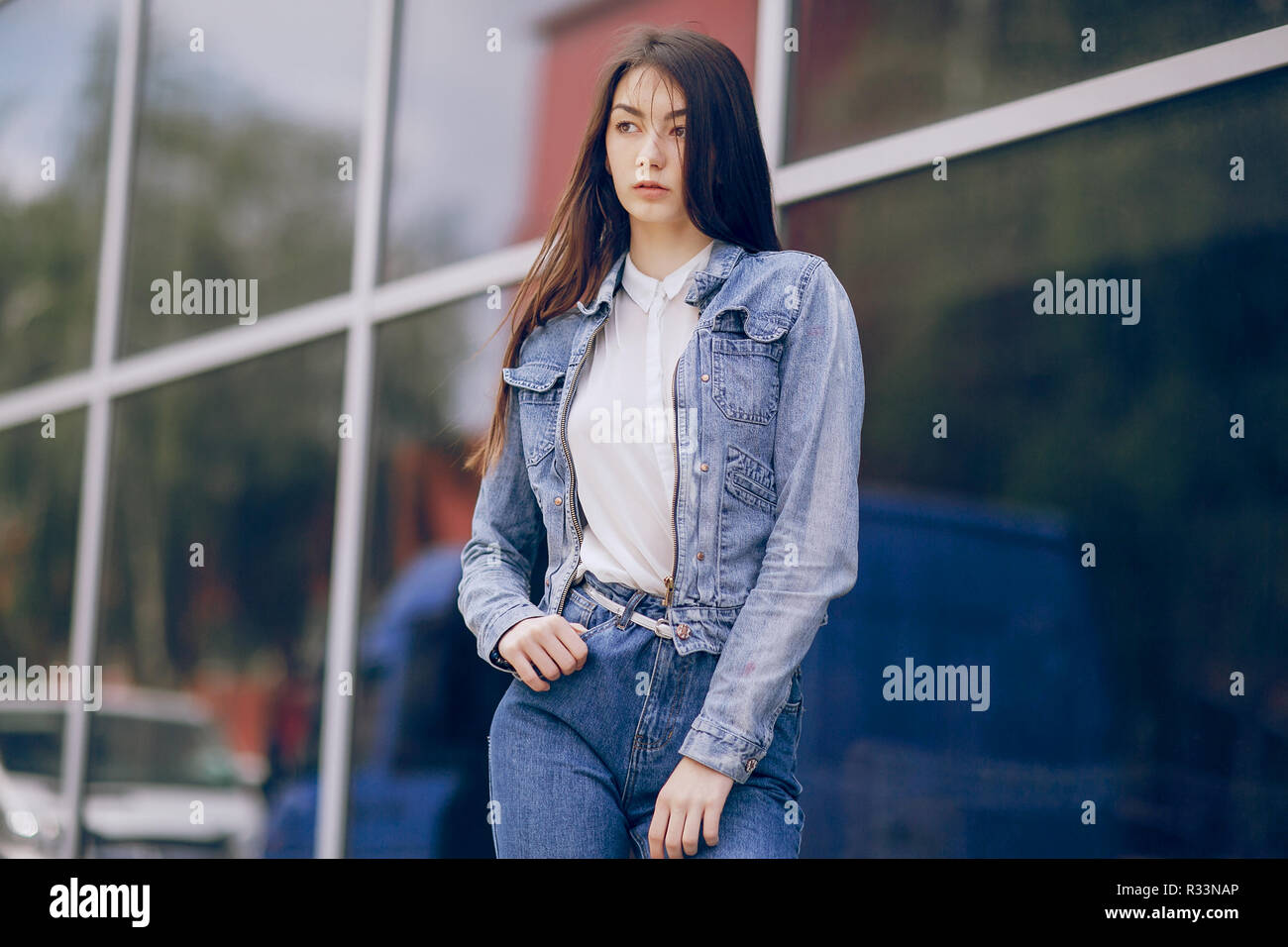 stylish young model walk in the street and pose for a photo on a Sunny ...