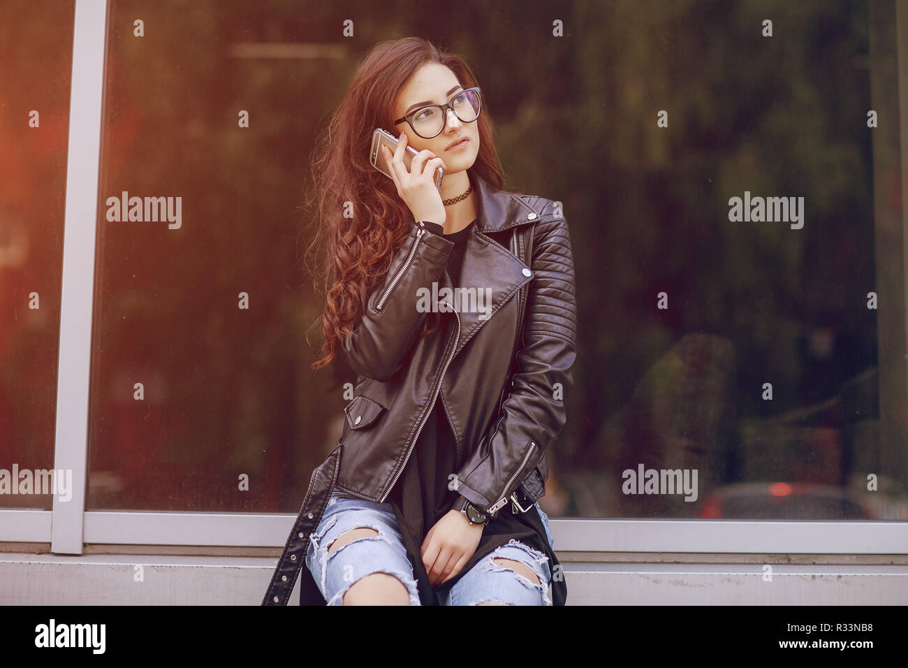 stylish young model walk in the street and pose for a photo on a Sunny ...