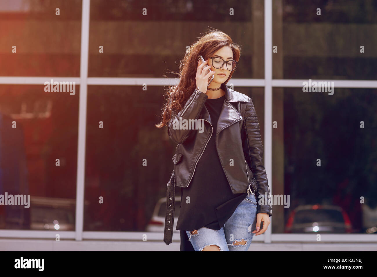 stylish young model walk in the street and pose for a photo on a Sunny ...