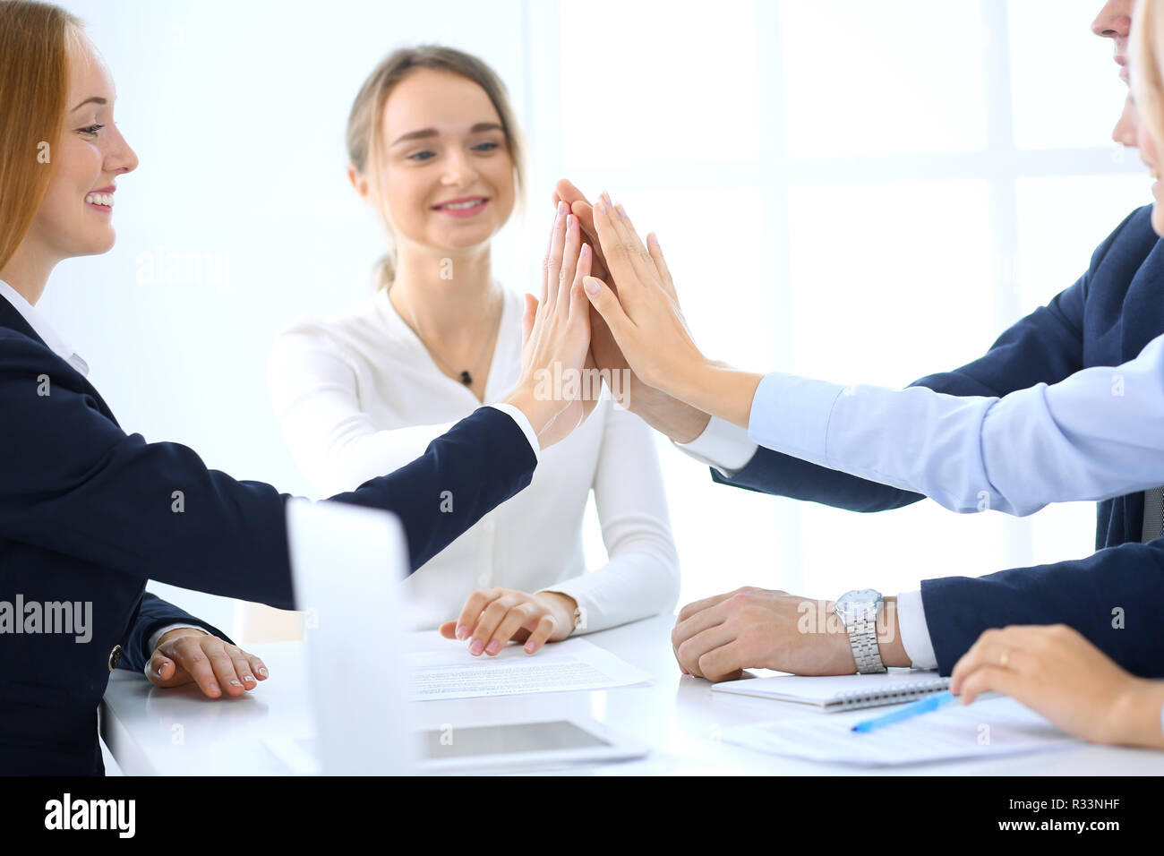 Business people happy showing teamwork and giving five showing unity ...