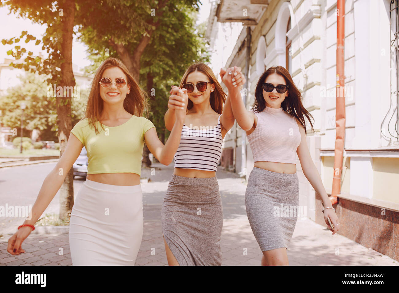 three beautiful girls walking around the city Stock Photo - Alamy