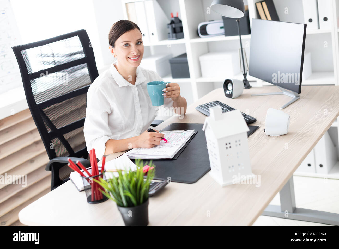 A young girl working in the office at the computer Stock Photo - Alamy