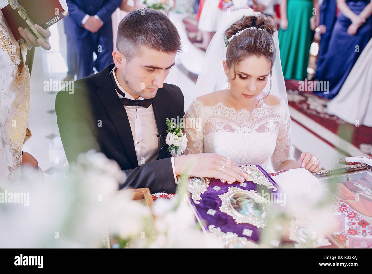 the bride and groom marry in the Church Stock Photo - Alamy