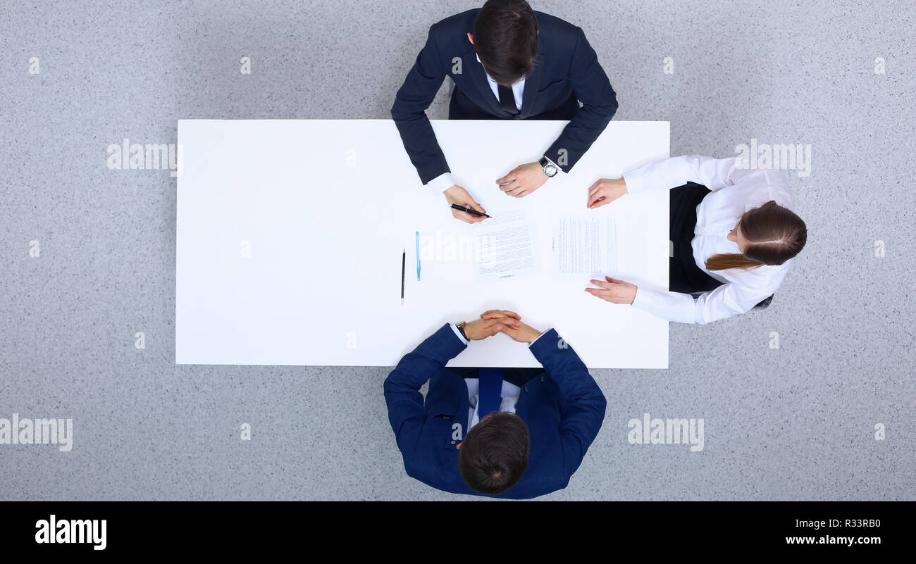 Group of business people and lawyer discussing contract papers sitting ...