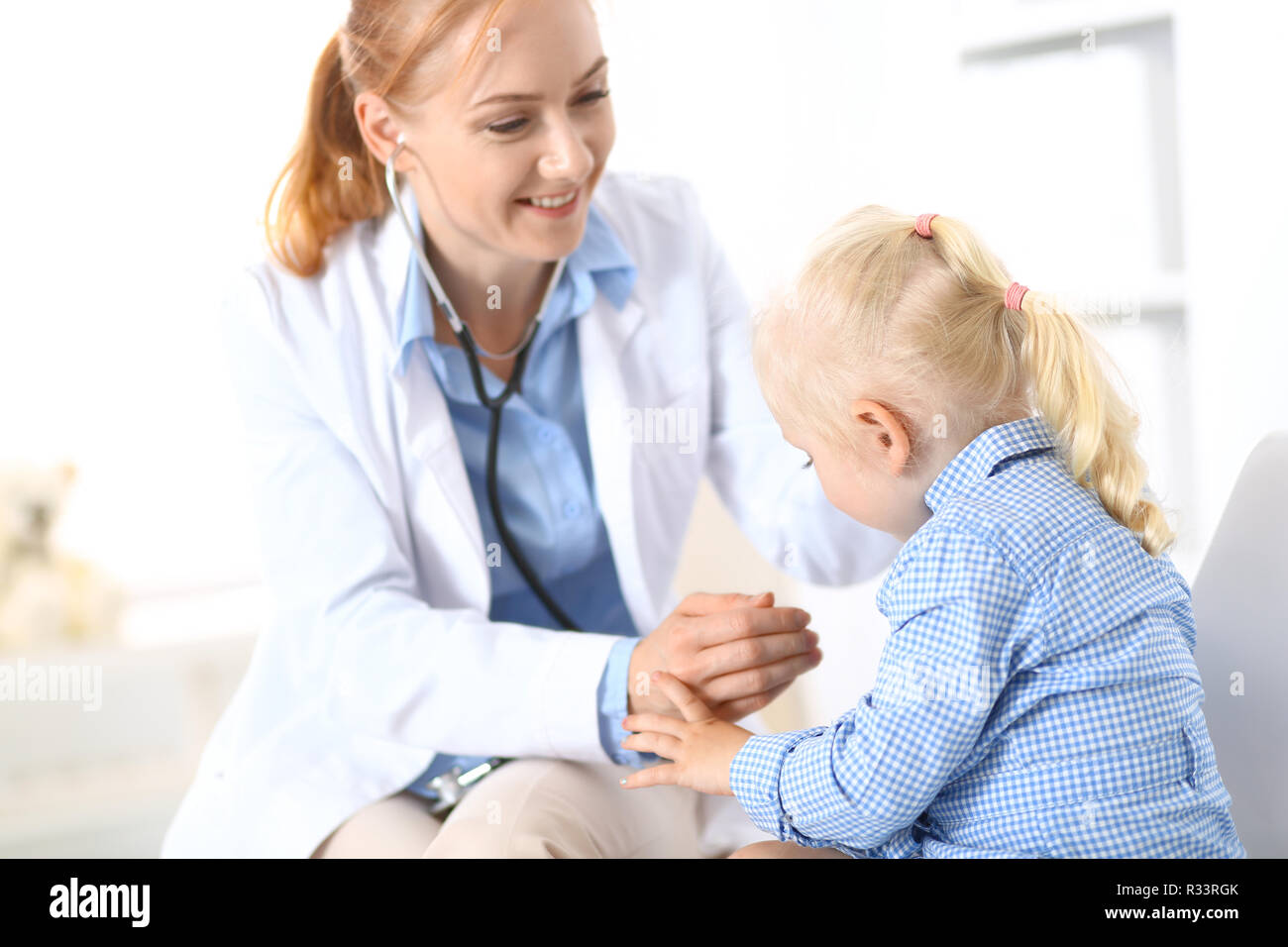 Doctor and a little blonde girl. Medicine and healthcare concept Stock ...
